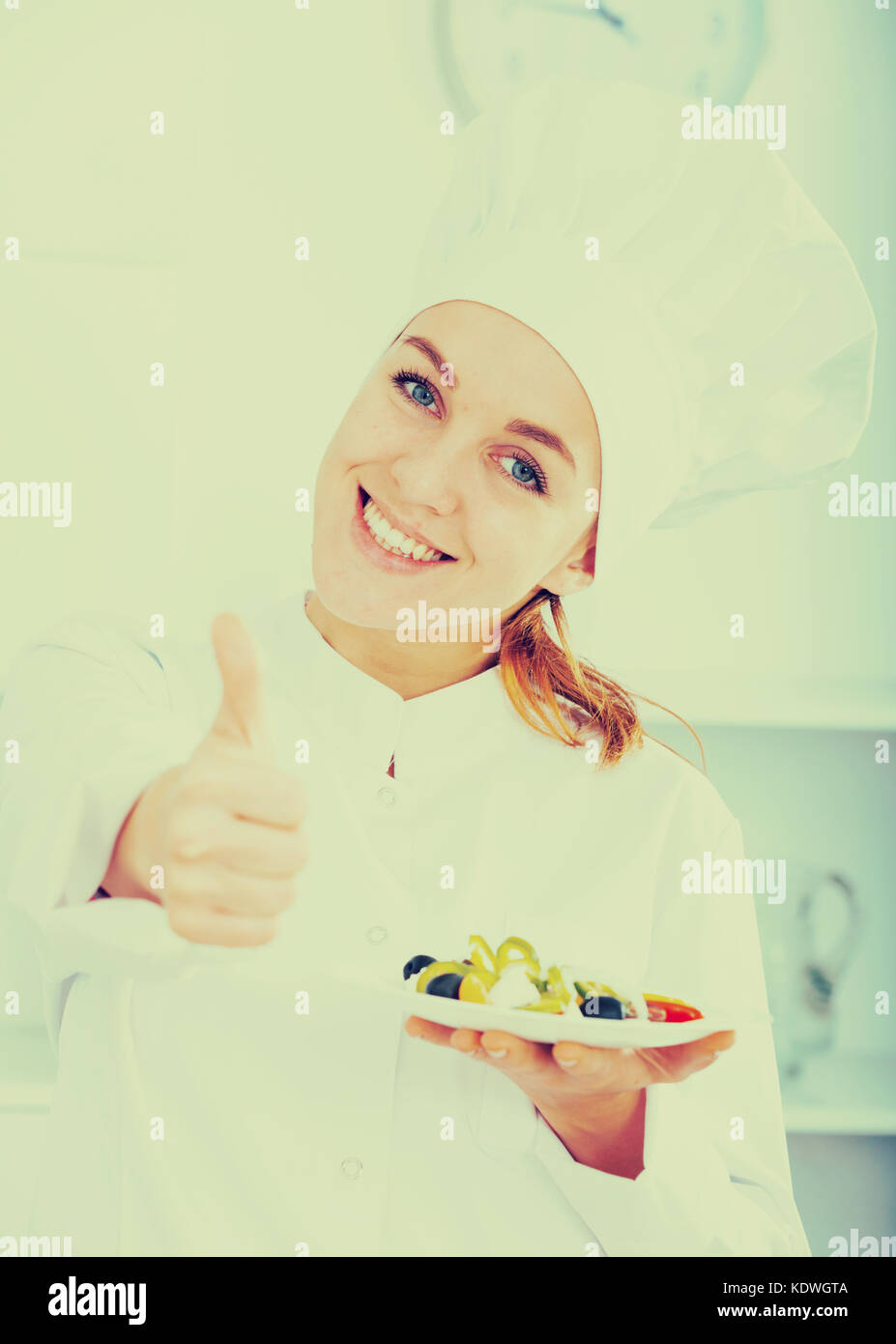 smiling girl cook with chestnut hair shows plate of salad Stock Photo ...