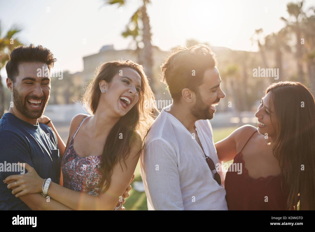 Portrait of two happy couples having fun outside laughing Stock Photo ...