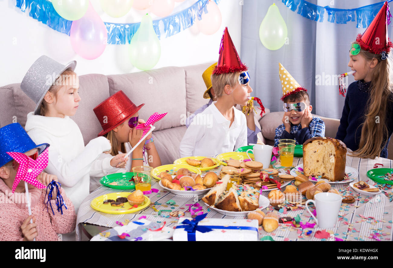 Cheerful children having fun during friend’s birthday party Stock Photo ...