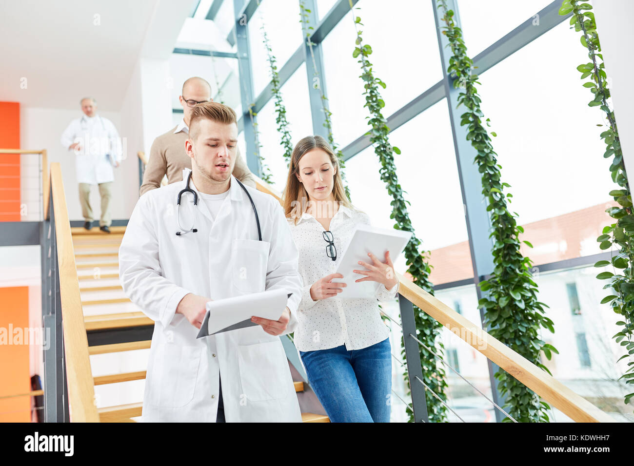 Young man as doctor or physician with team in hospital Stock Photo - Alamy