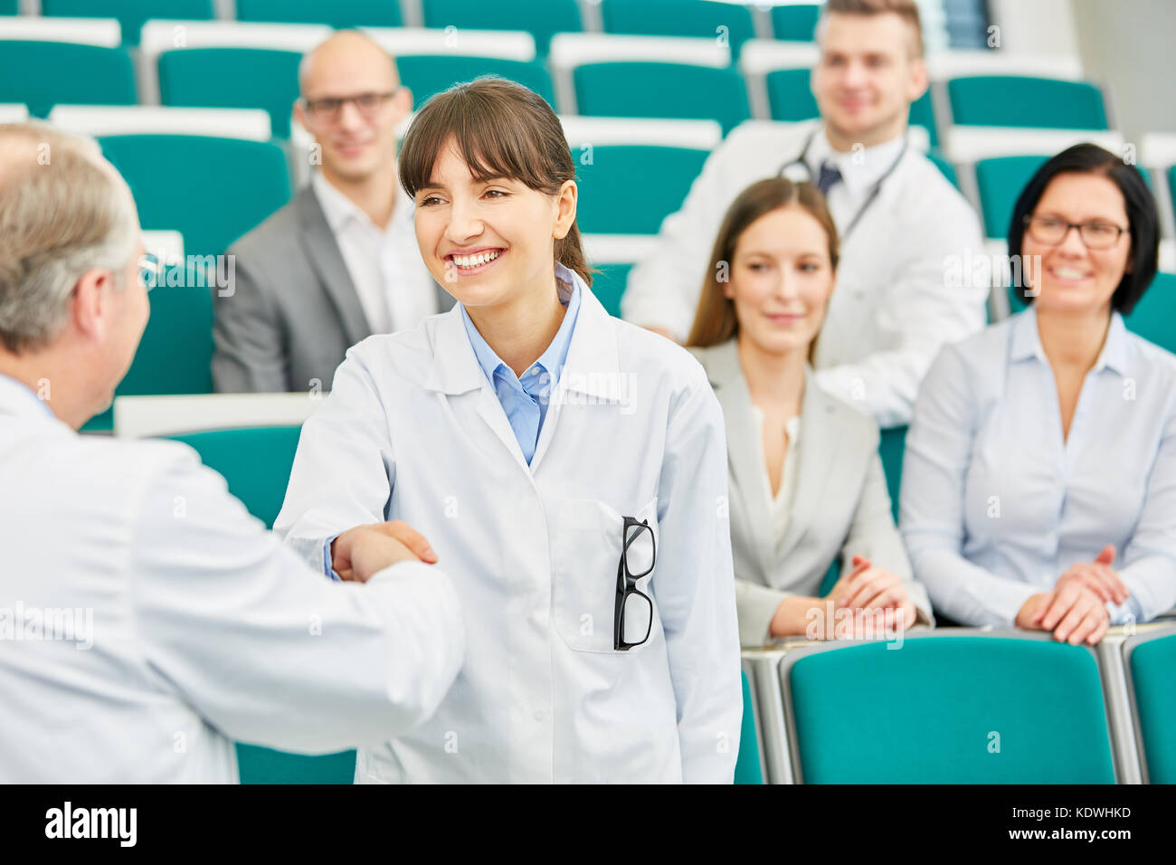 Congratulations handshake between doctor and student for successful ...