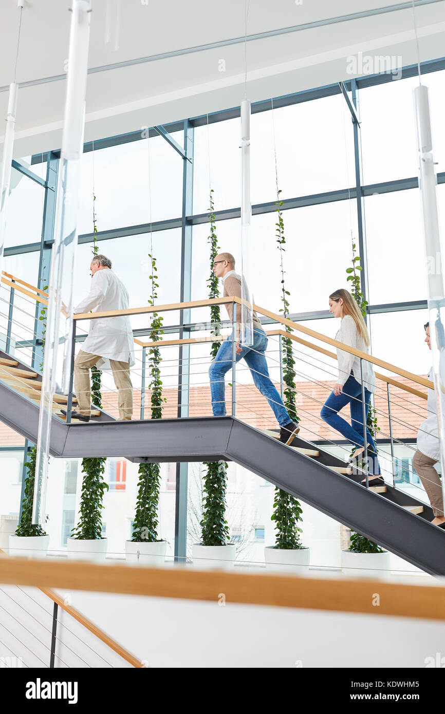 Hospital team group of doctors staff walk on staircase Stock Photo - Alamy