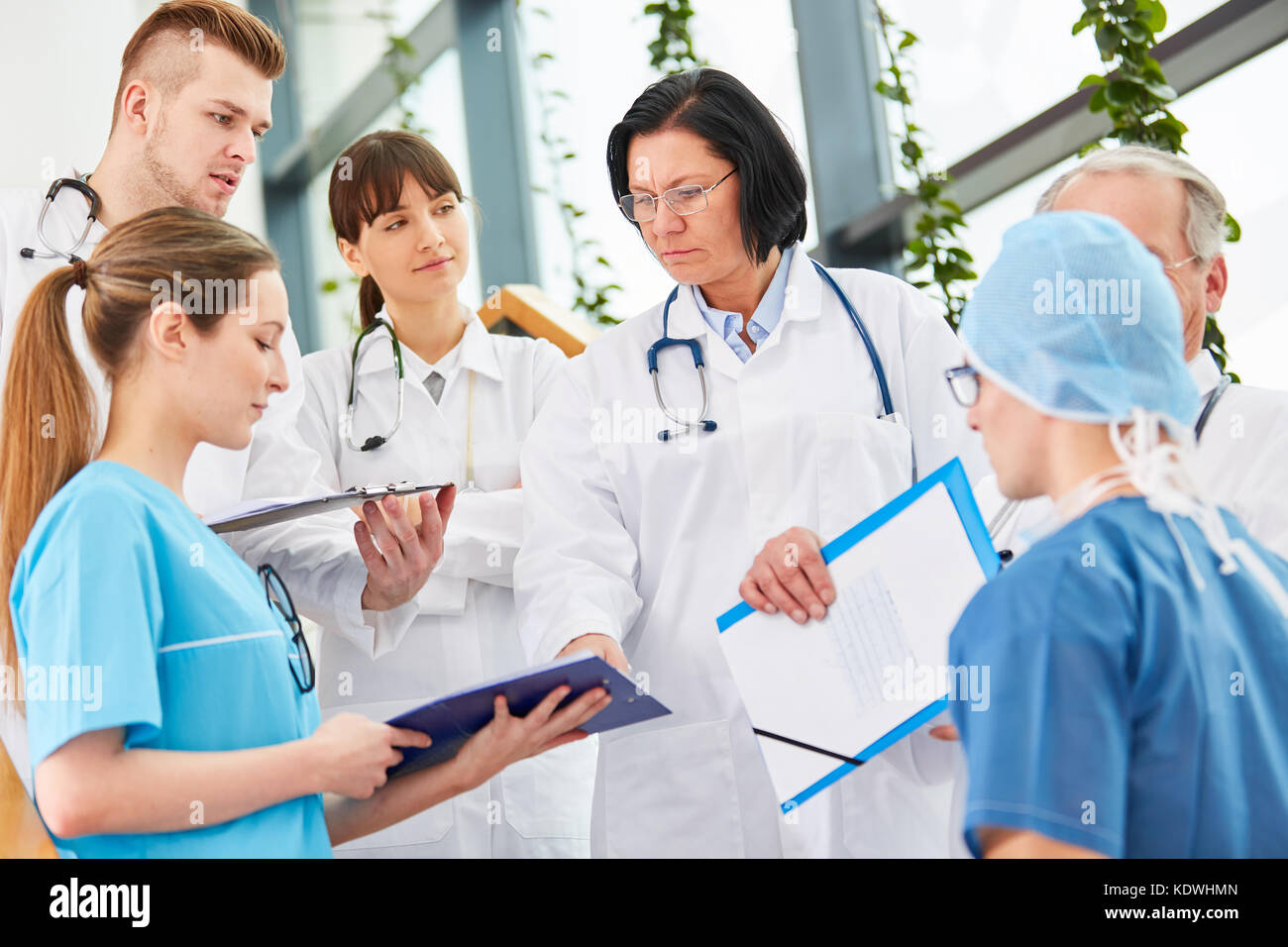 Team of doctors and chief physician with authority Stock Photo - Alamy