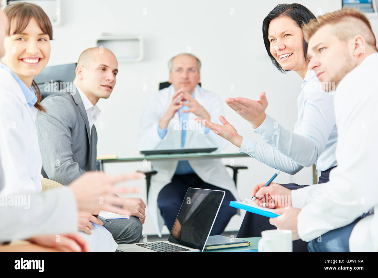 Clinic employee staff in a meeting discuss medical information in ...