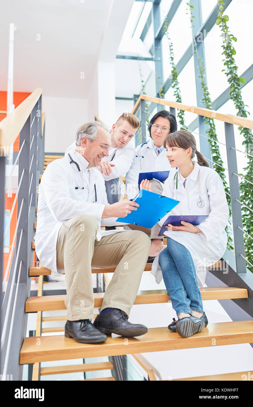 Doctors in team meeting on hospital staircase Stock Photo - Alamy
