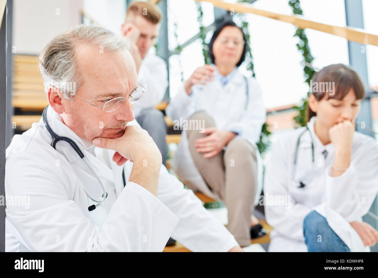 Doctors brainstorming on difficult problem on hospital staircase Stock ...