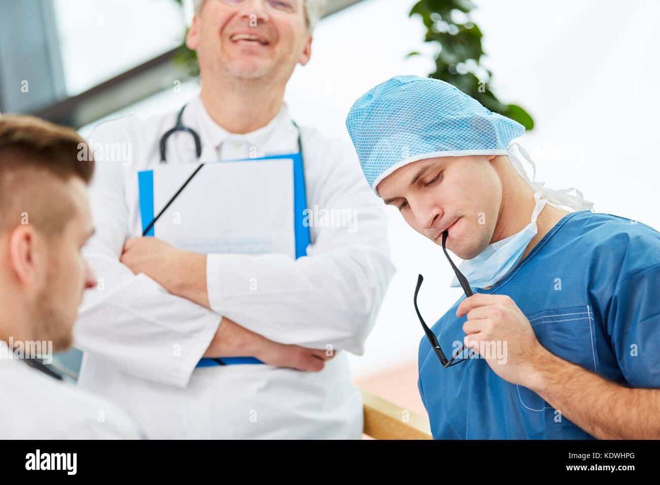 Young man as surgeon planning with intensive Care team Stock Photo - Alamy