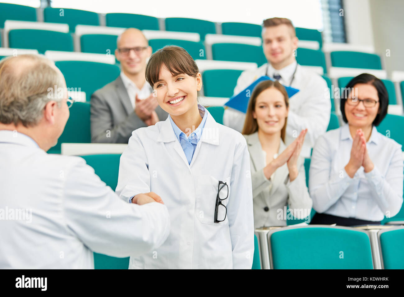 Doctor share hadshake with student to congratulate successful medical ...