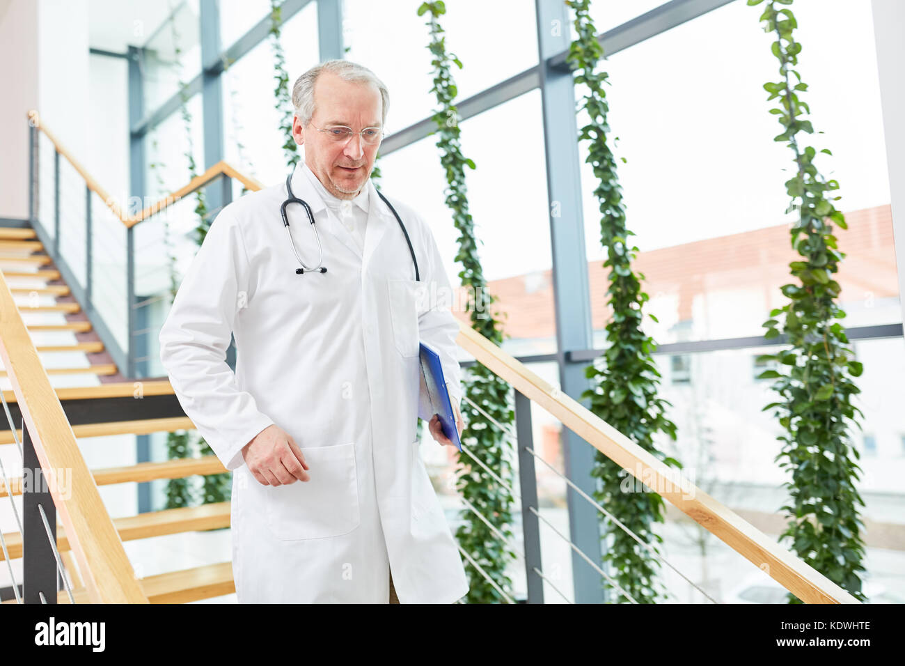Senior man as doctor or chief physician on hospital staircase Stock ...