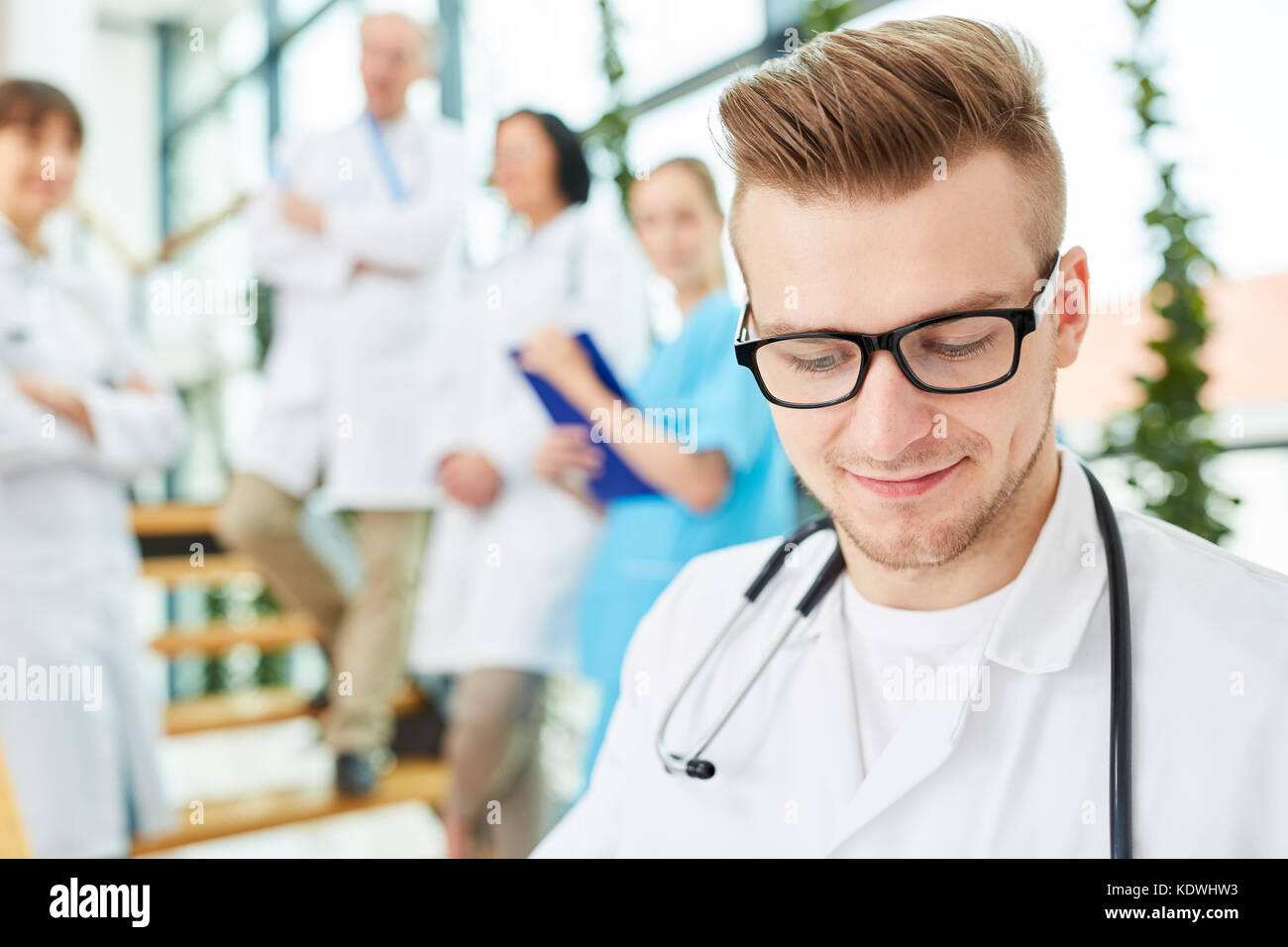 Young man as doctor or physician student in apprenticeship Stock Photo ...