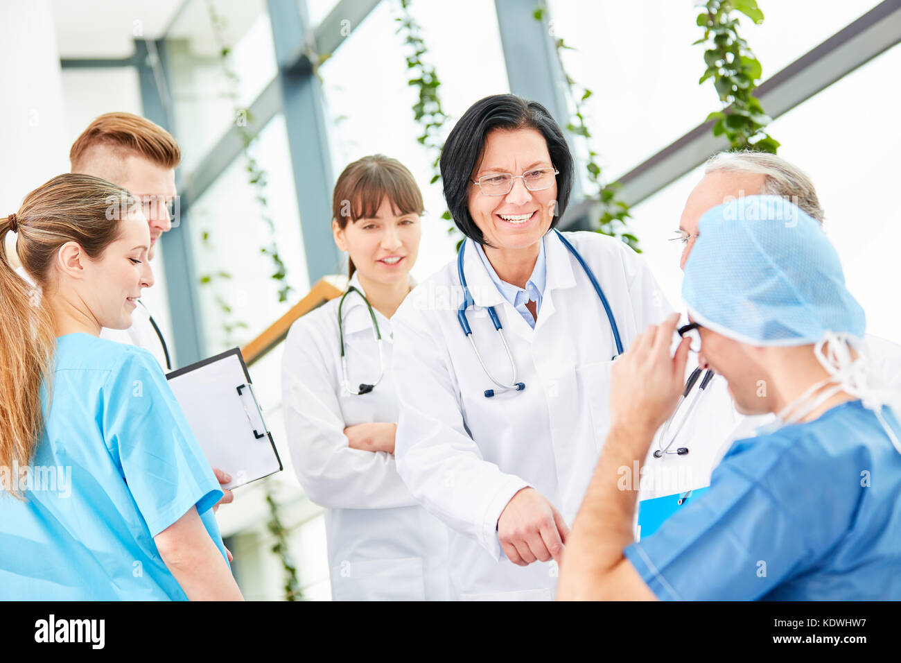 Senior chief doctor with team of doctors working in cooperation Stock ...