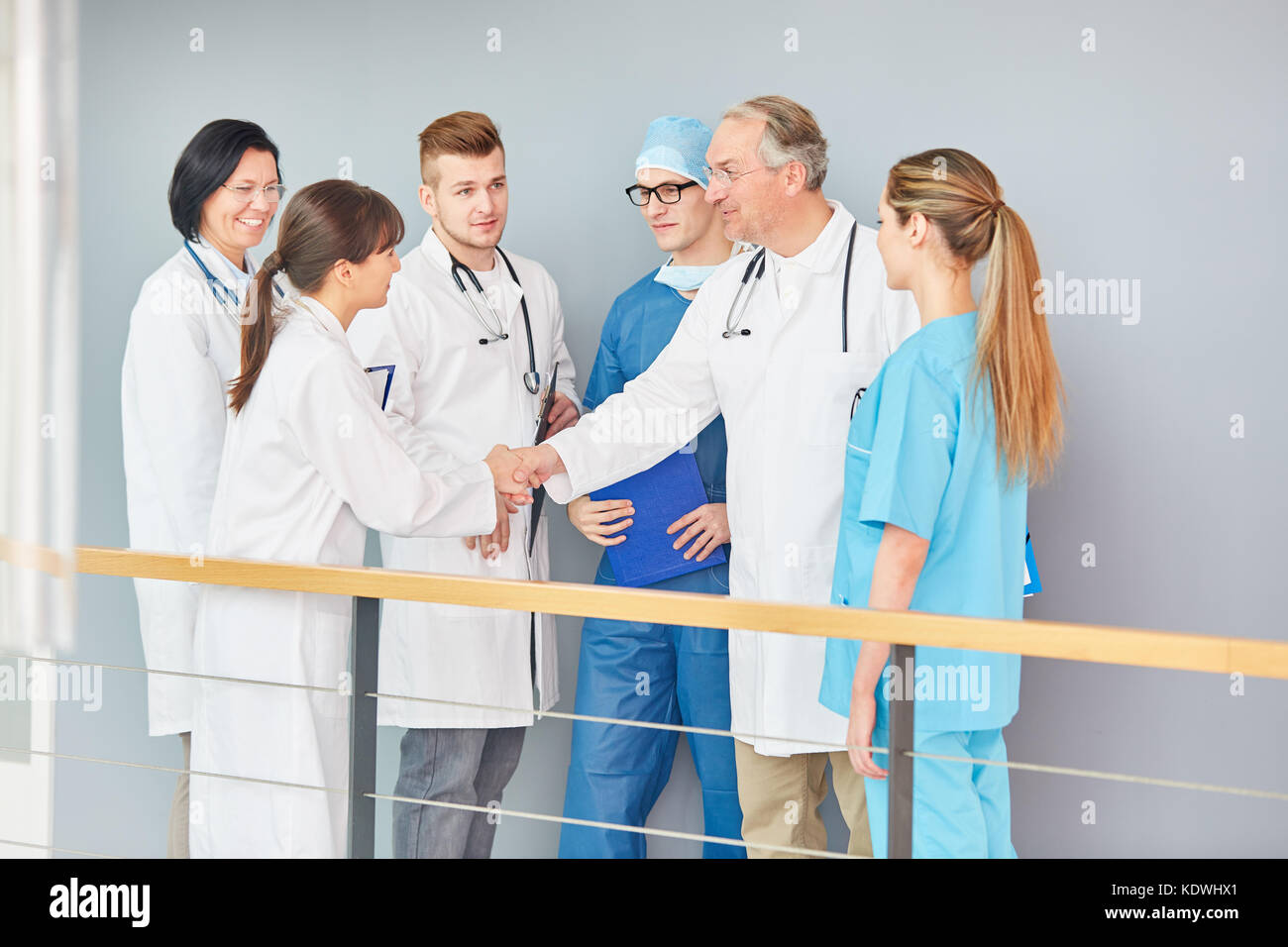 Chief doctor share handshake with team of physicians as welcome gesture ...