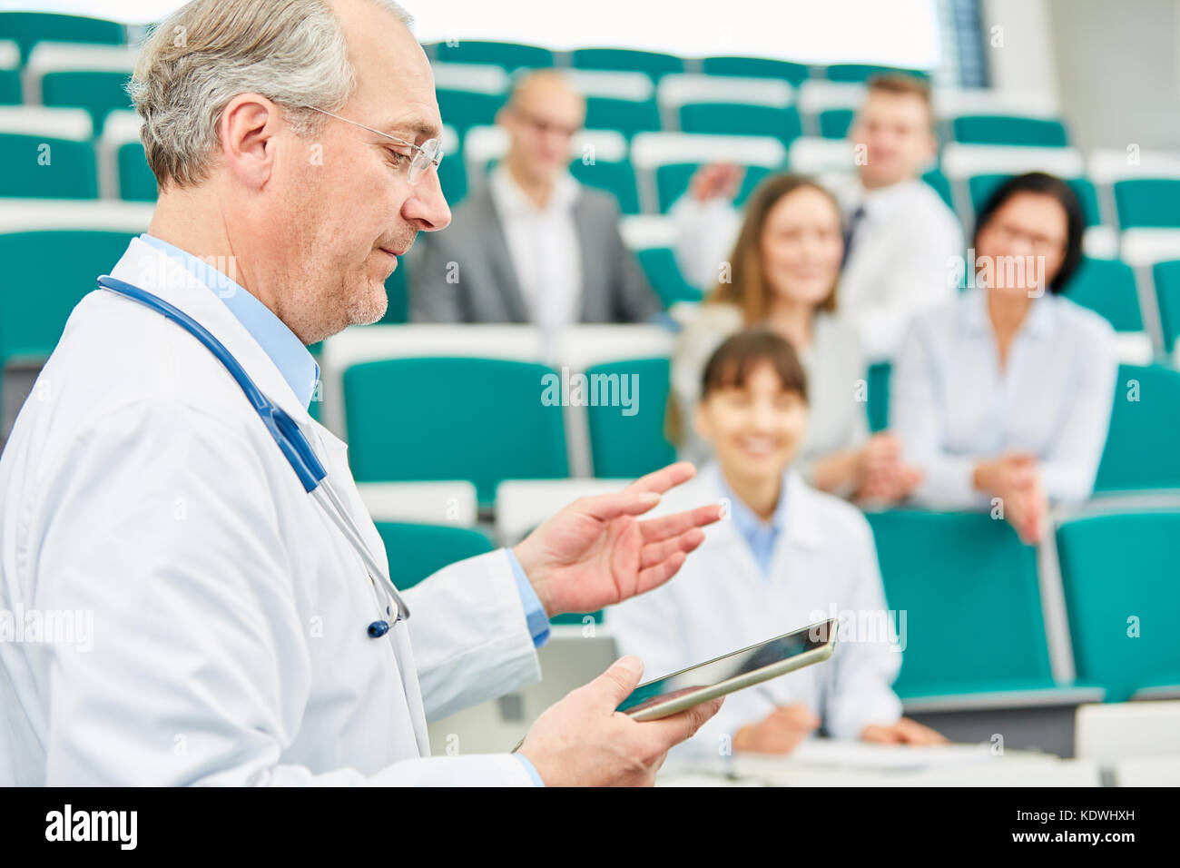 Senior medicine lecturer with tablet training doctors in university ...