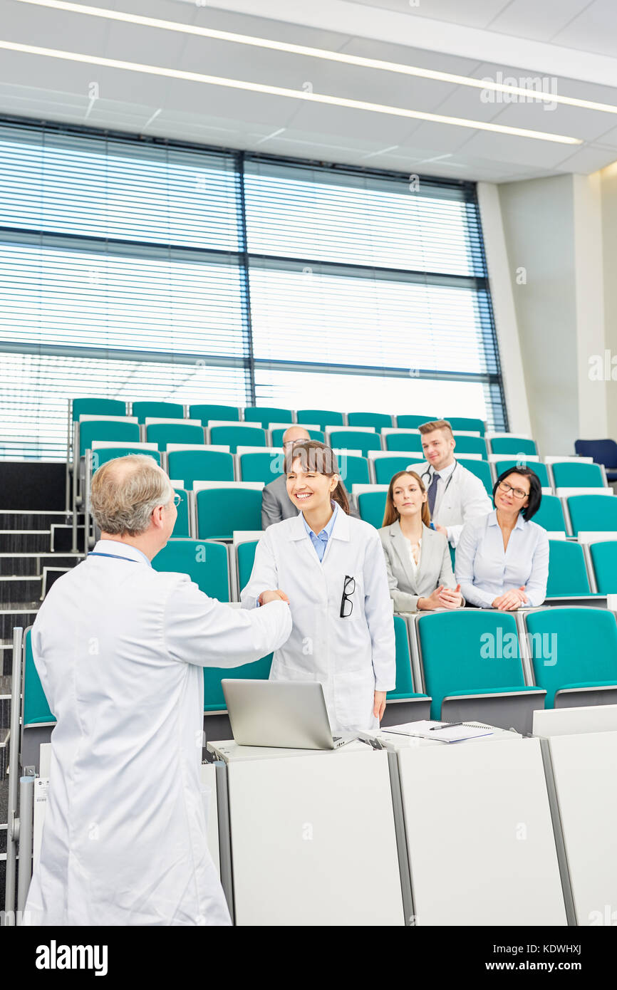 Professor congratulate student for successful medical school exam Stock ...