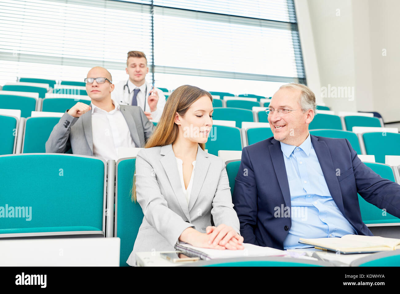 Young physician with many doctors in medicine seminar at university ...