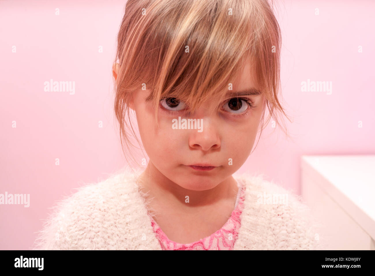 Close up small white caucasian blonde girl child sad expression looking ...