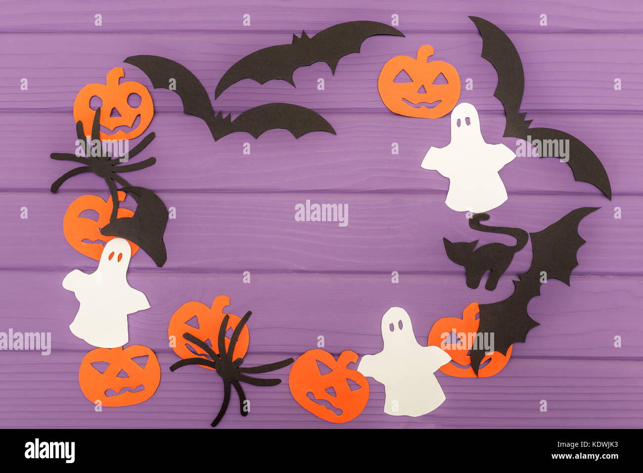 Halloween silhouettes cut out of paper made of round frame with ...