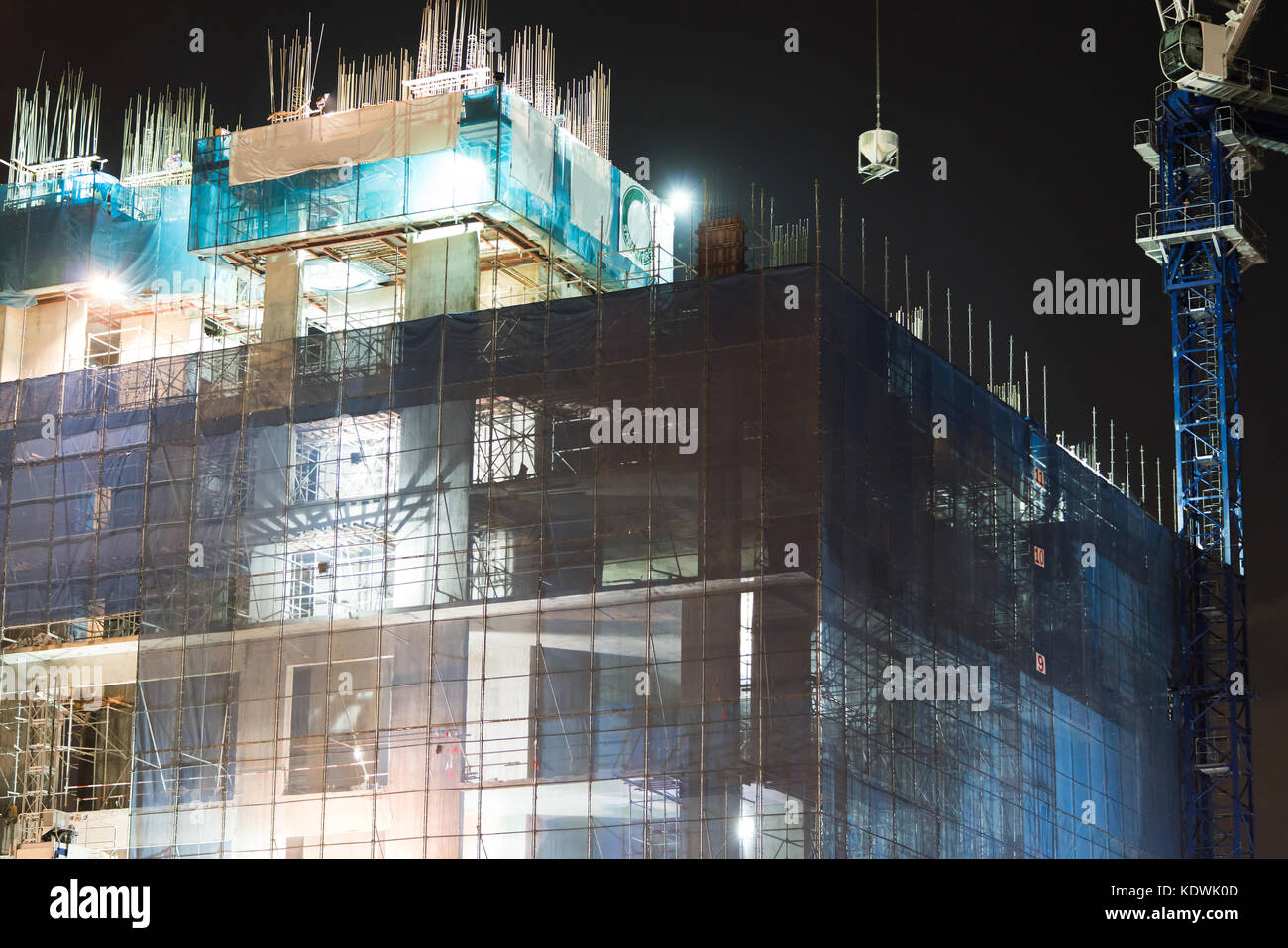 The construction of skyscrapers at night. The construction has ...
