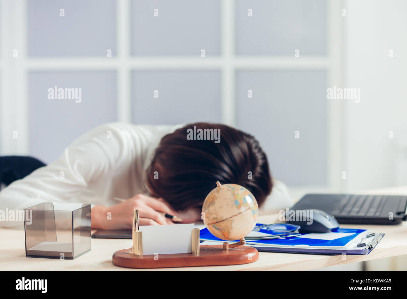 tired woman at office desk in the evening Stock Photo - Alamy