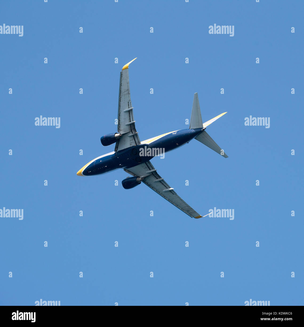 Underside of a twin engine jet taking off against a blue sky Stock ...