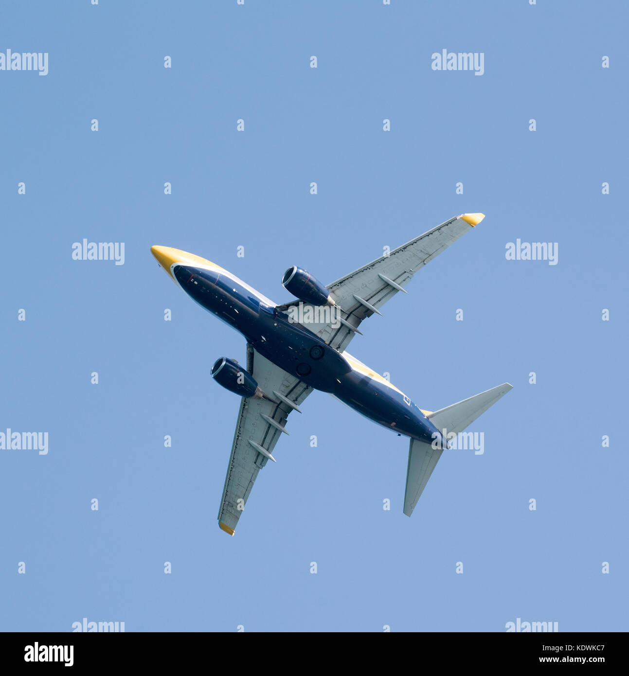 Underside of a twin engine jet taking off against a blue sky Stock ...