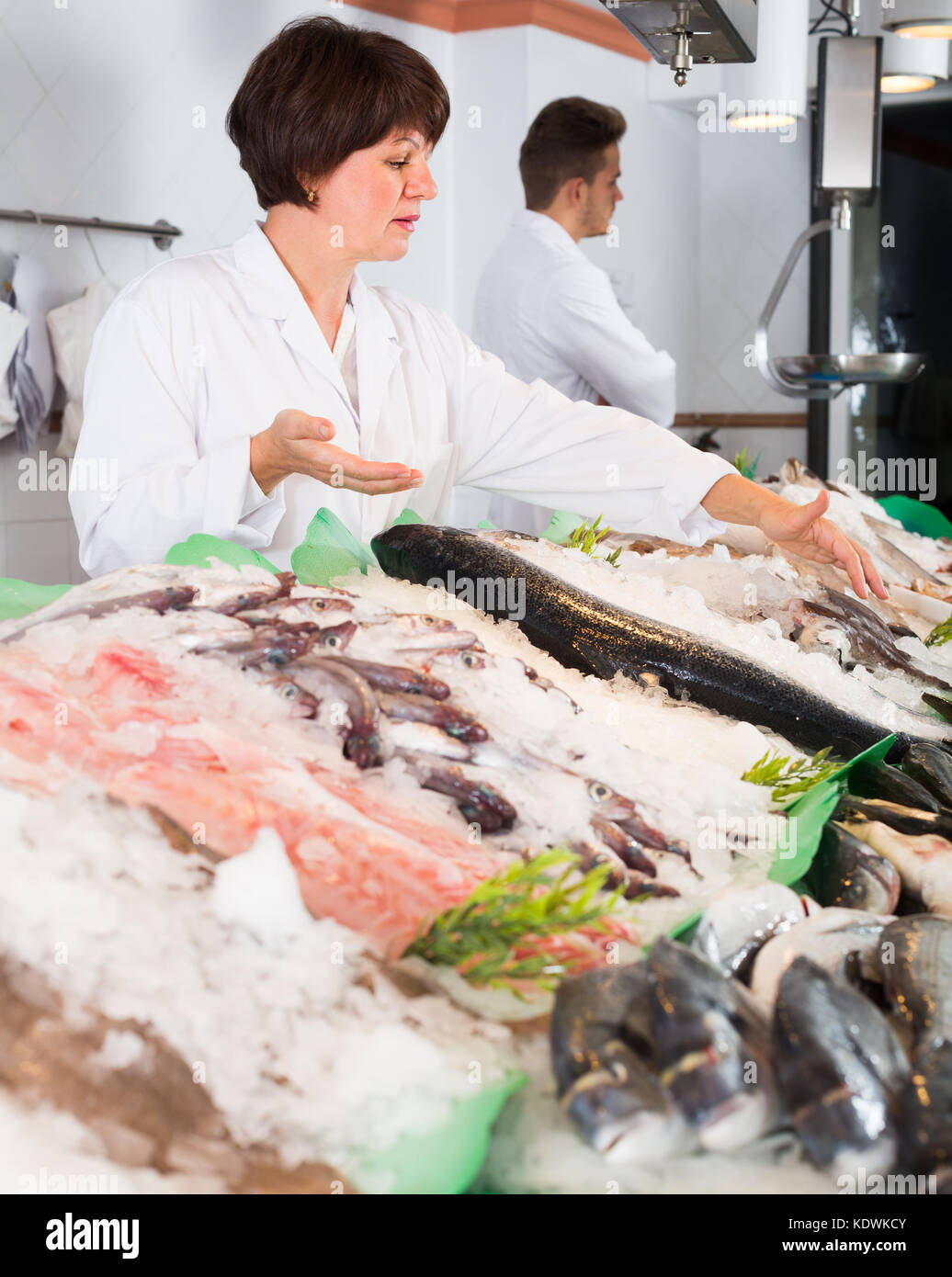 Ordinary fish and seafood store with two happy sellers indoors Stock ...
