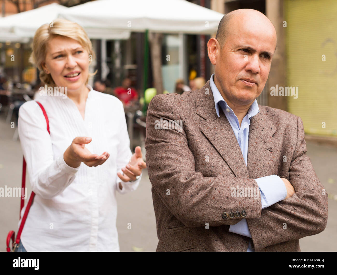 closeup of angry retiree man being sad with woman standing outdoors ...