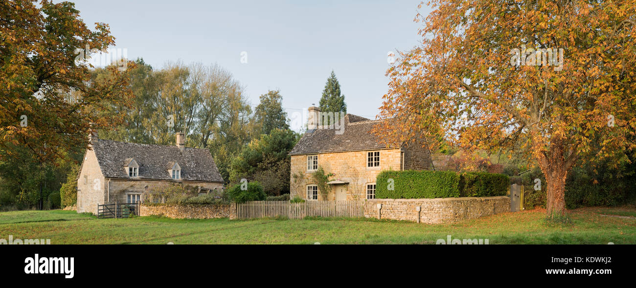 Cotswold stone cottages and autumn trees in Wyck Rissington, Cotswolds ...