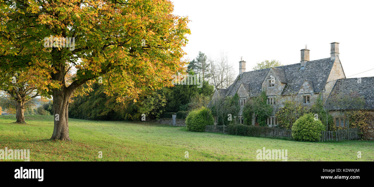 Cotswold stone cottage and autumn trees in Wyck Rissington, Cotswolds ...