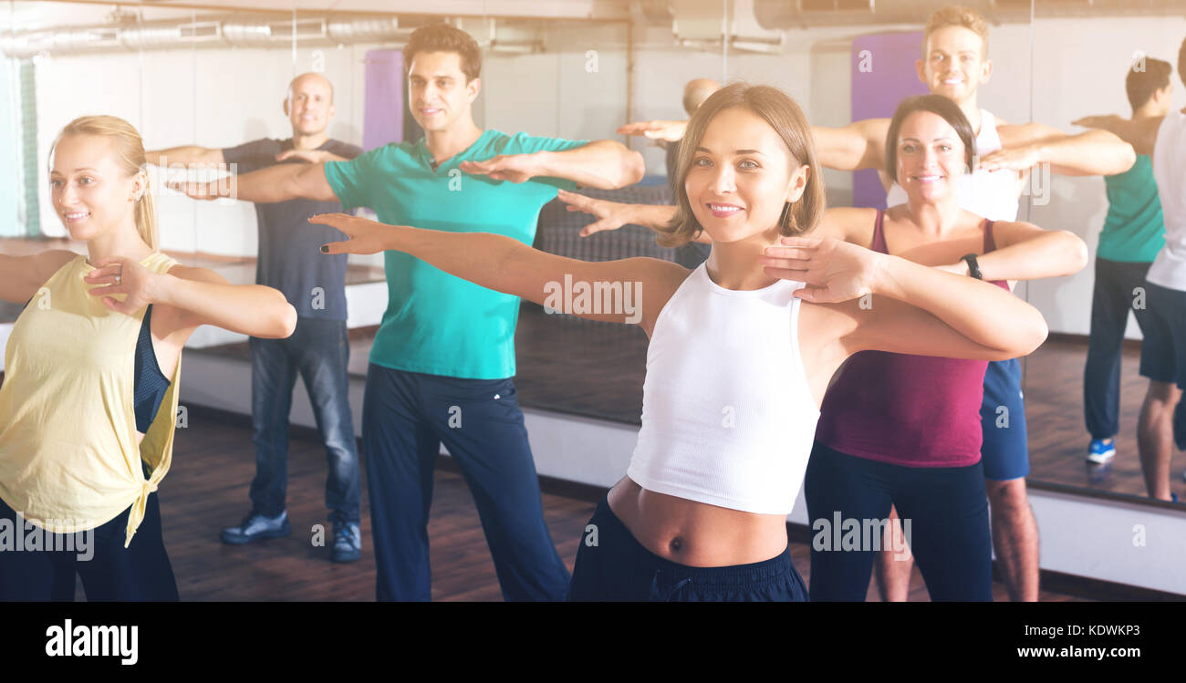 Portrait of smiling young men and ladies dancing zumba at lesson Stock ...