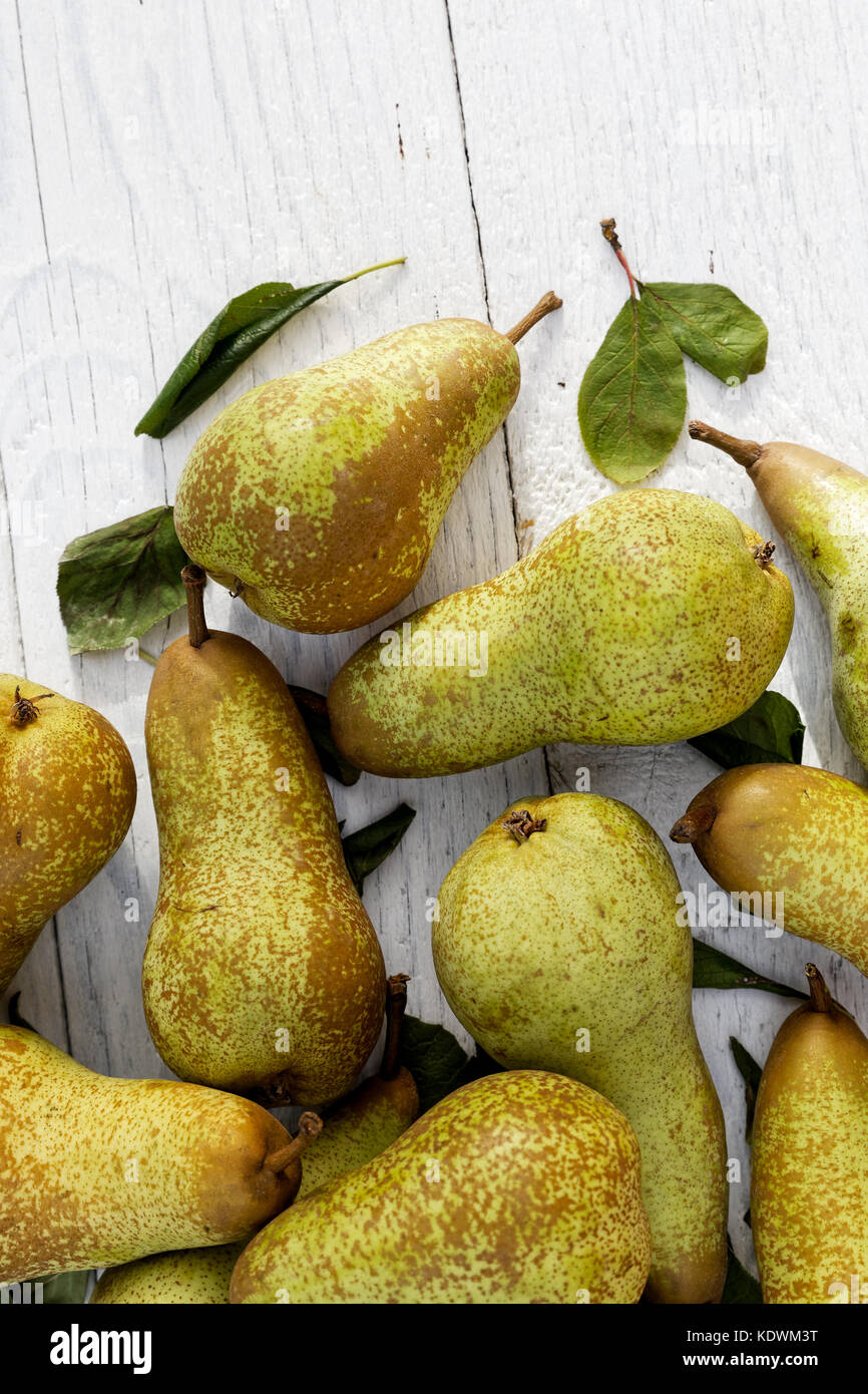 Abate fetel pears with leaves on white painted wood from above. Space ...