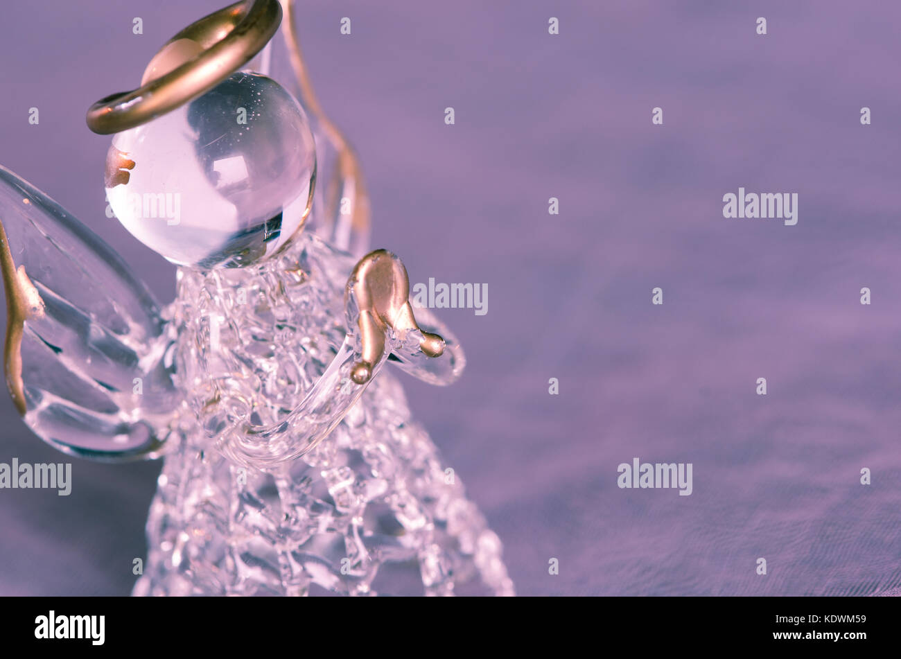little vitreous angel on purple background Stock Photo - Alamy