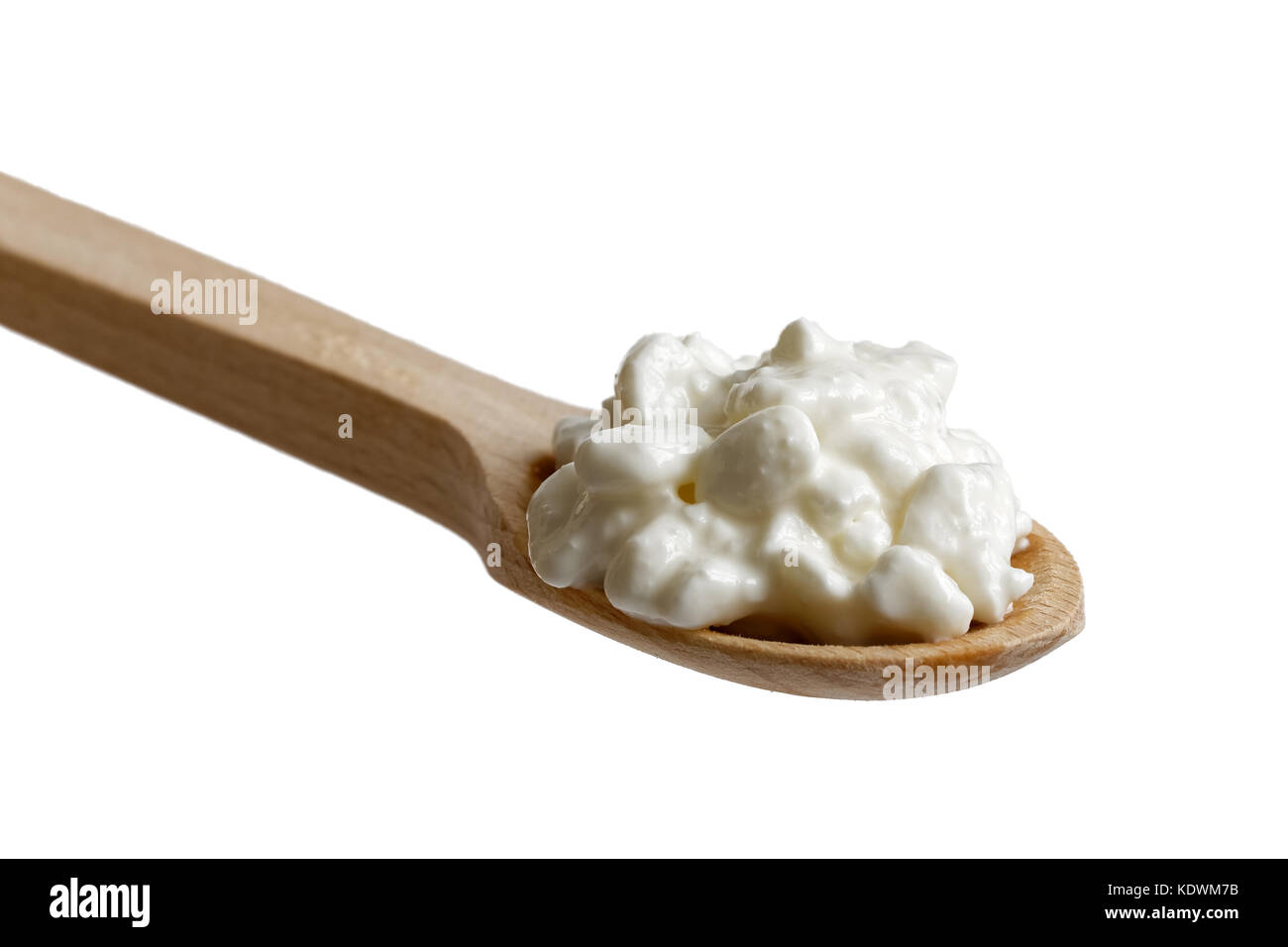 Chunky cottage cheese on wooden spoon isolated on white Stock Photo - Alamy