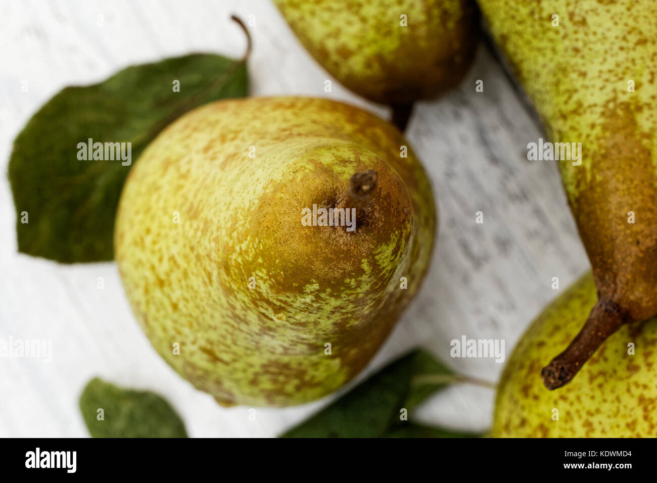 Closeup of abate fetel pear with leaves on white painted wood from ...