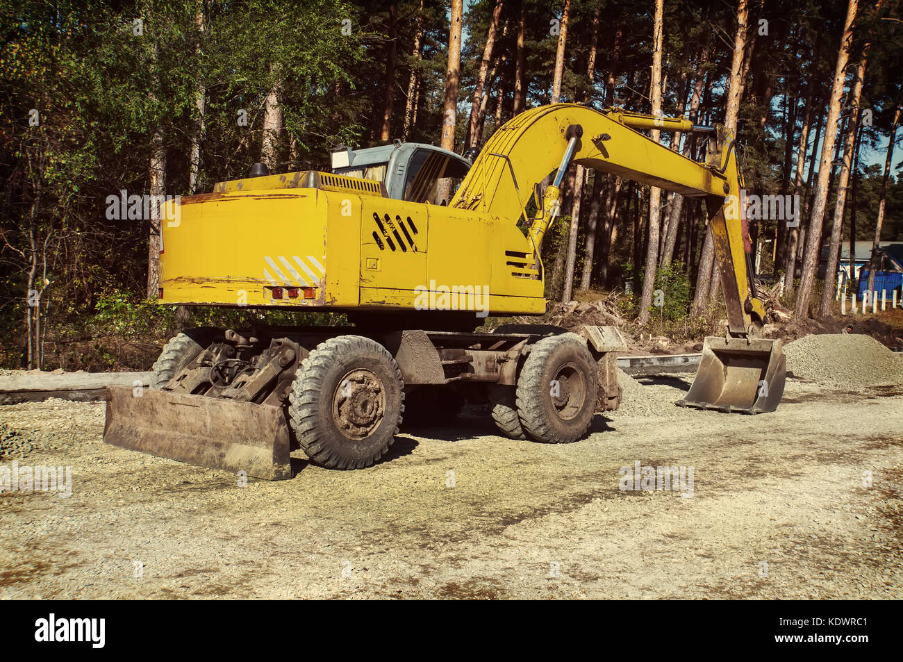 The modern excavator performs excavation work on the construction site ...