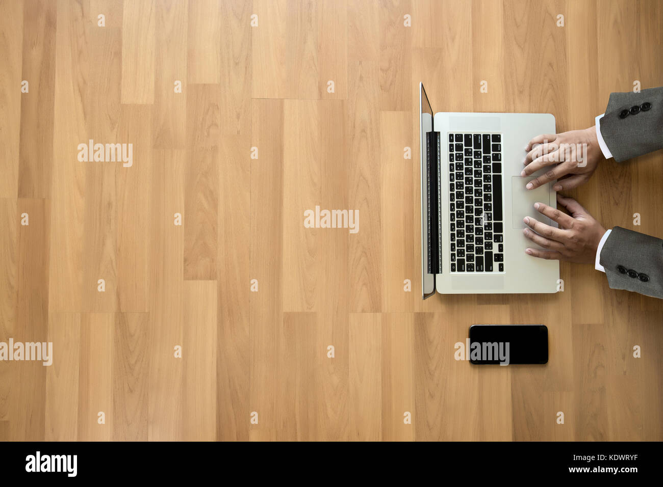 Top view man used of laptop hands on a wooden desktop and copy space ...