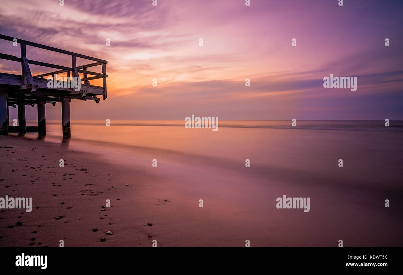 Panoramic picture of a sunset over wooden pier on the sea beach in ...