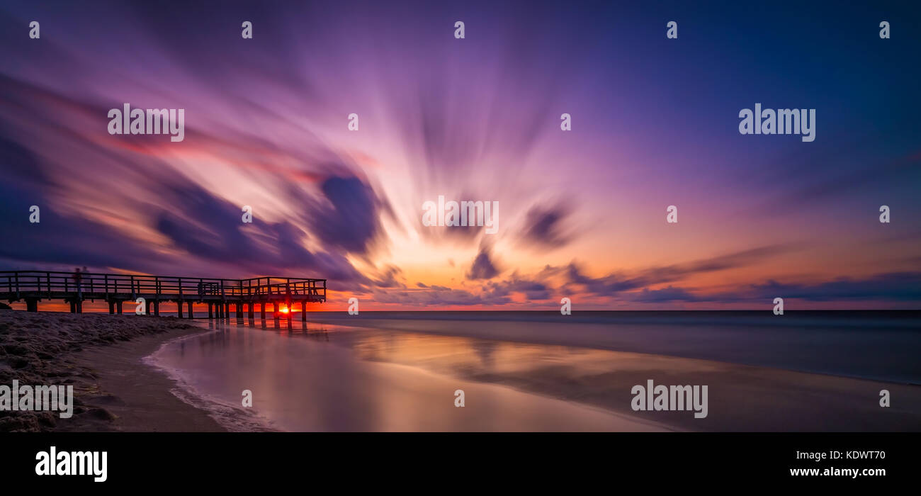 Panoramic picture of a sunset over wooden pier on the sea beach in ...