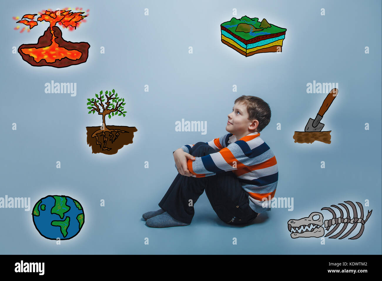 Teenage boy sitting on the floor looking up and smiling geology Stock ...