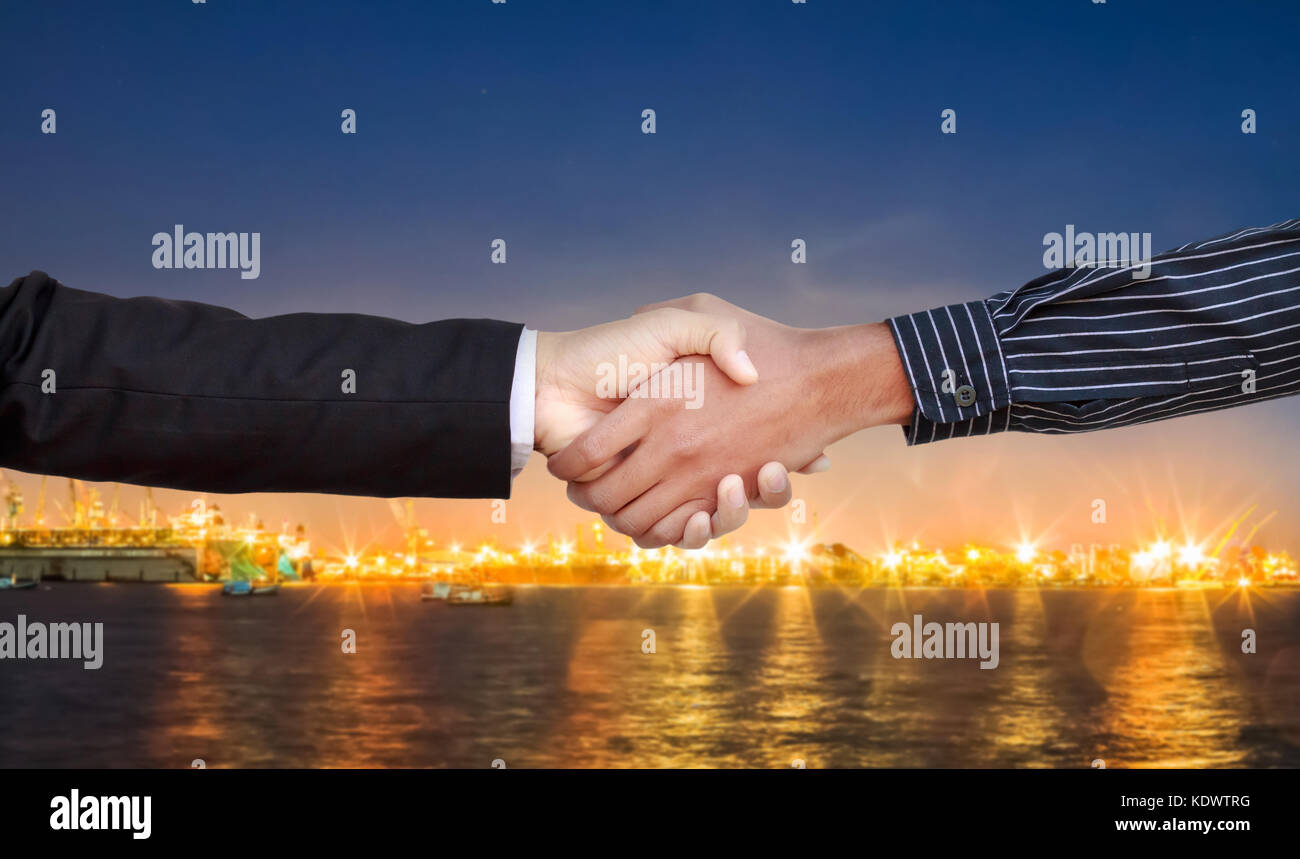 Businessman handshake with ship transportation logistic background ...