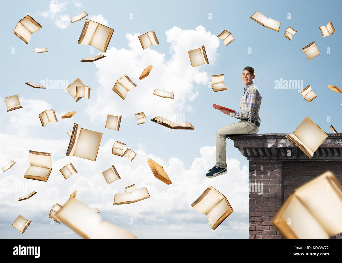 Man reading book and many of them flying in air Stock Photo - Alamy