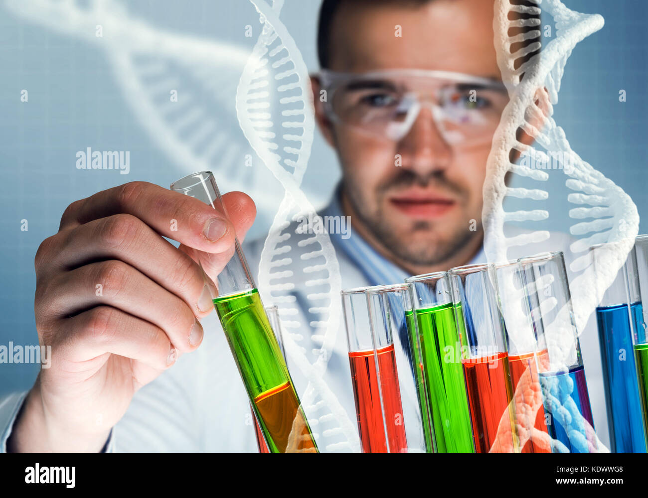 Young scientist mixing reagents in glass flask in clinical laboratory ...