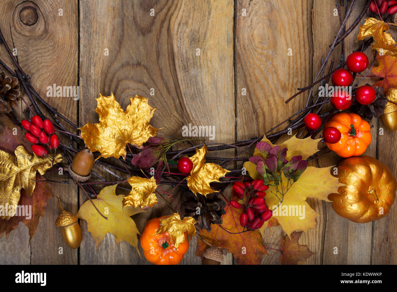 Thanksgiving background with golden pumpkin, acorn and maple leaves ...