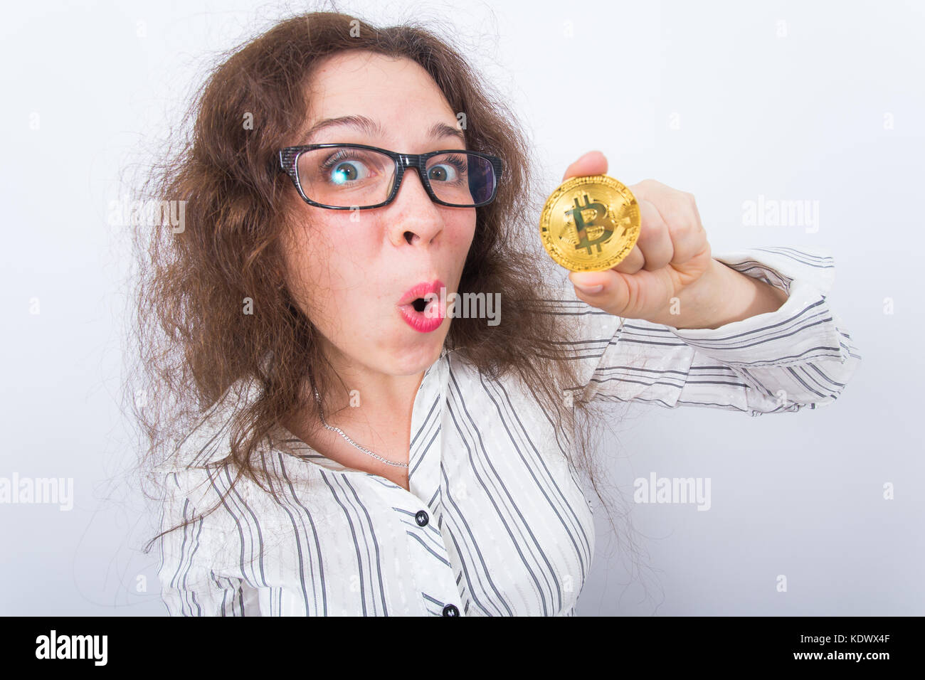Surprised business woman showing Golden Bitcoin coin and thumbs up ...