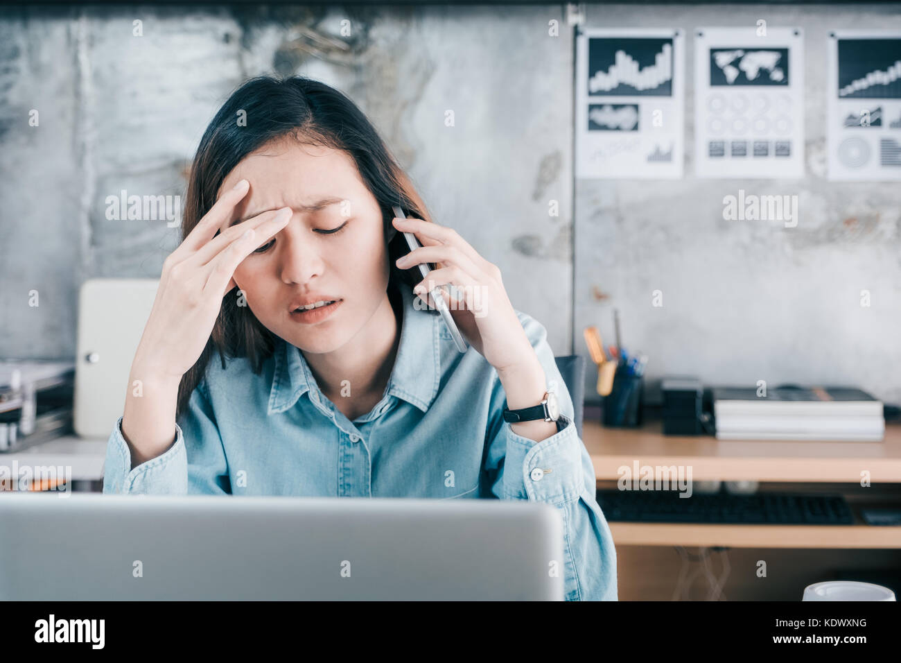 Stressed Asian creative designer woman cover her face with hand and ...