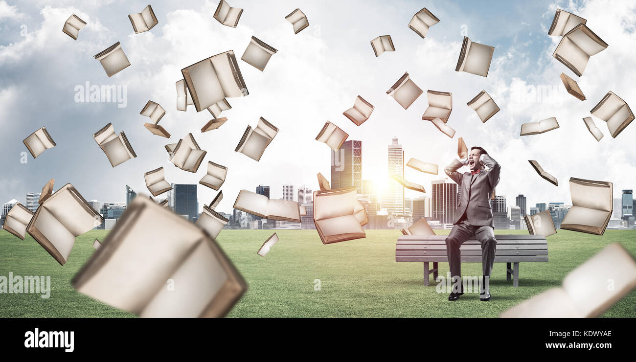 Many old books falling from above and student guy sitting on ben Stock ...