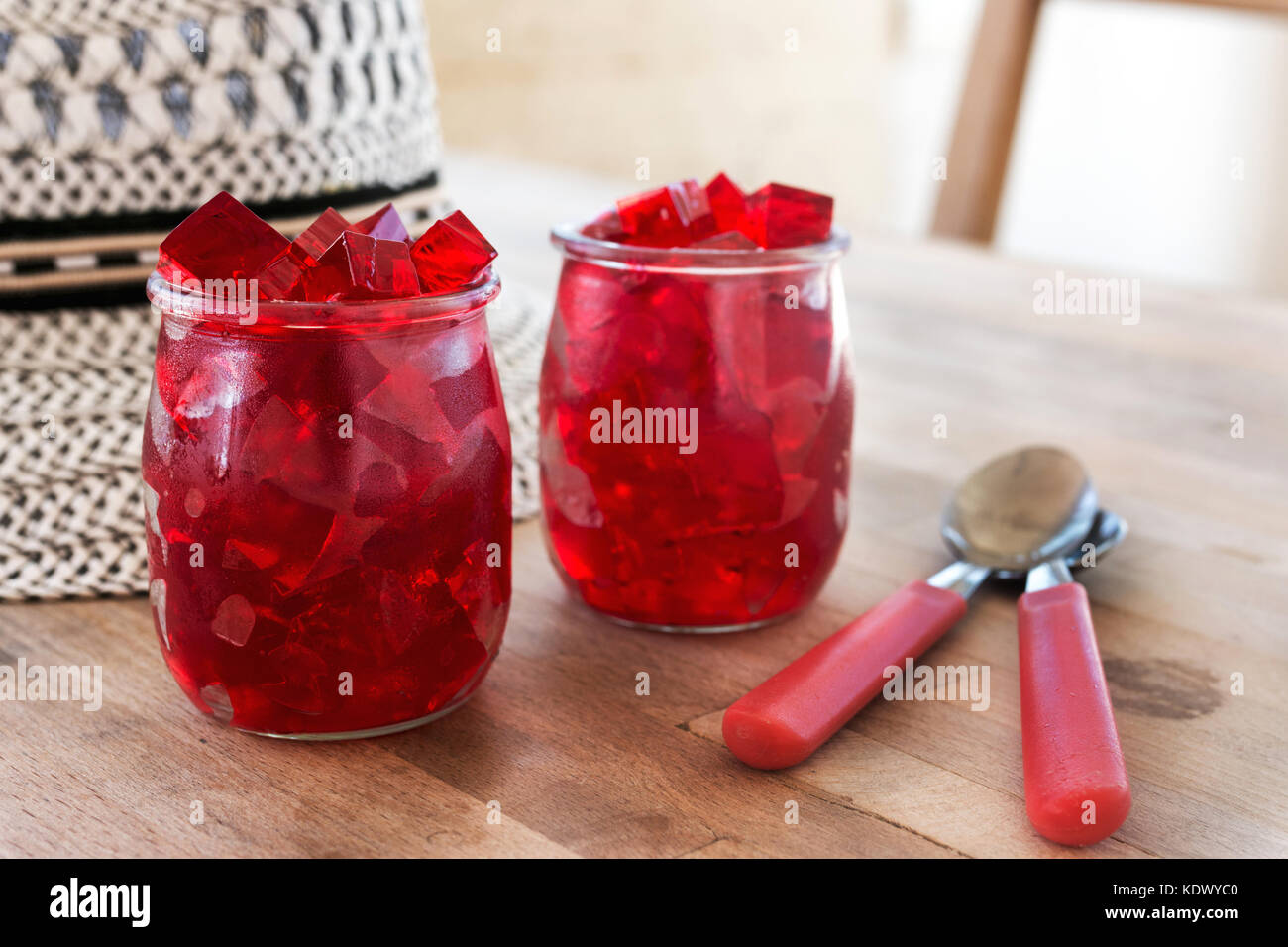 red jelly, cut into dice, inside two glasses of glass, on the table ...