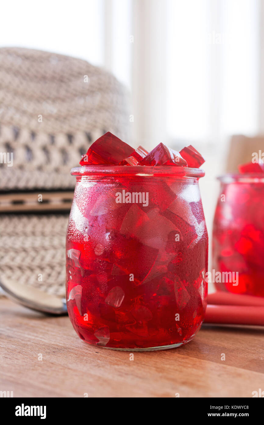 red jelly, cut into dice, inside two glasses of glass, on the table ...