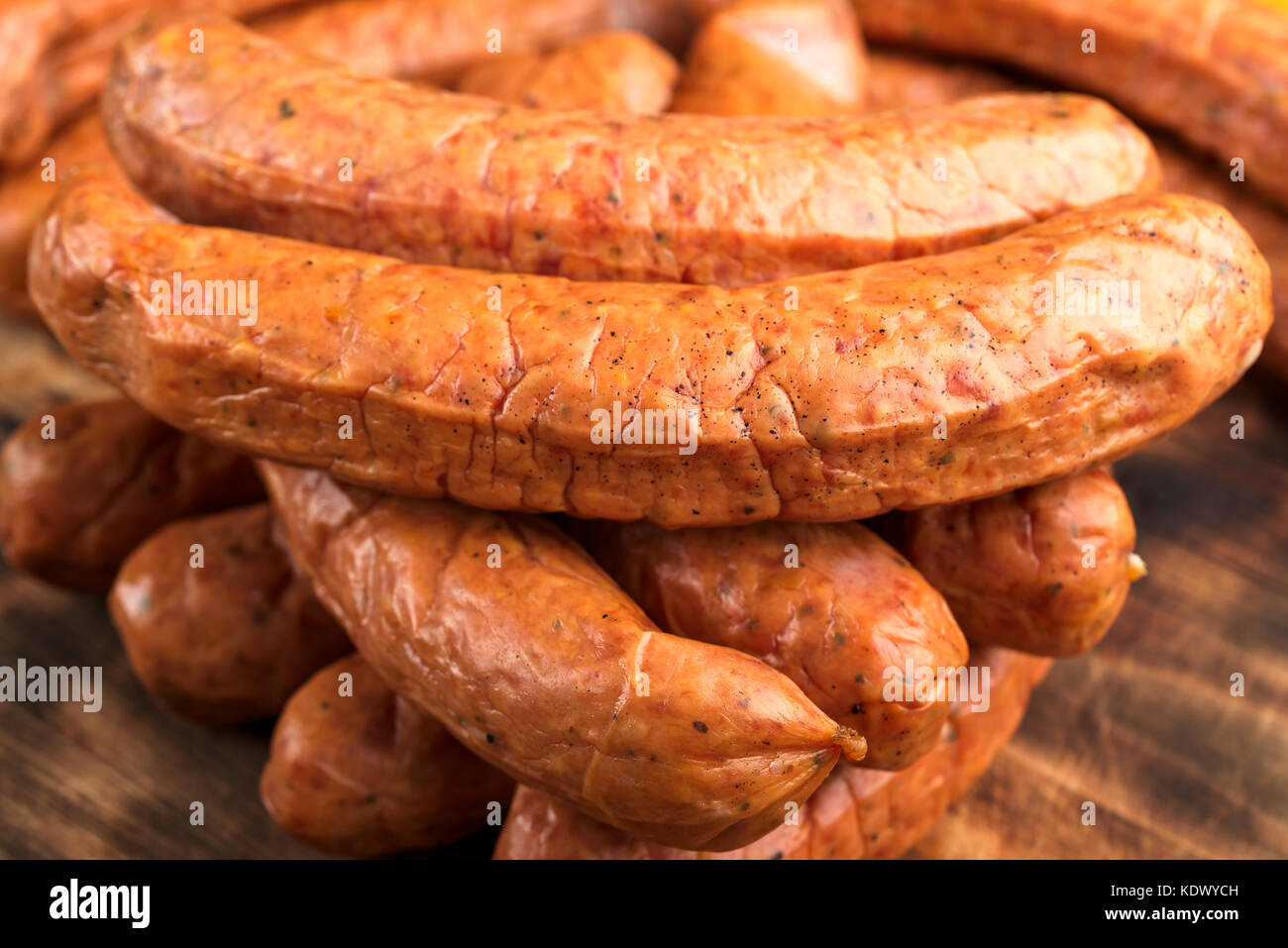 Pile of deliciously cold smoked handmade sausages with visible black ...