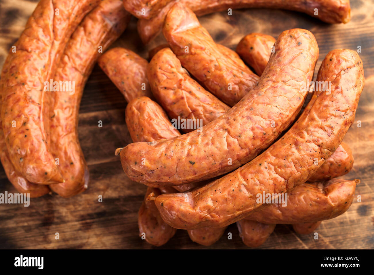 Pile of deliciously cold smoked handmade sausages with visible black ...